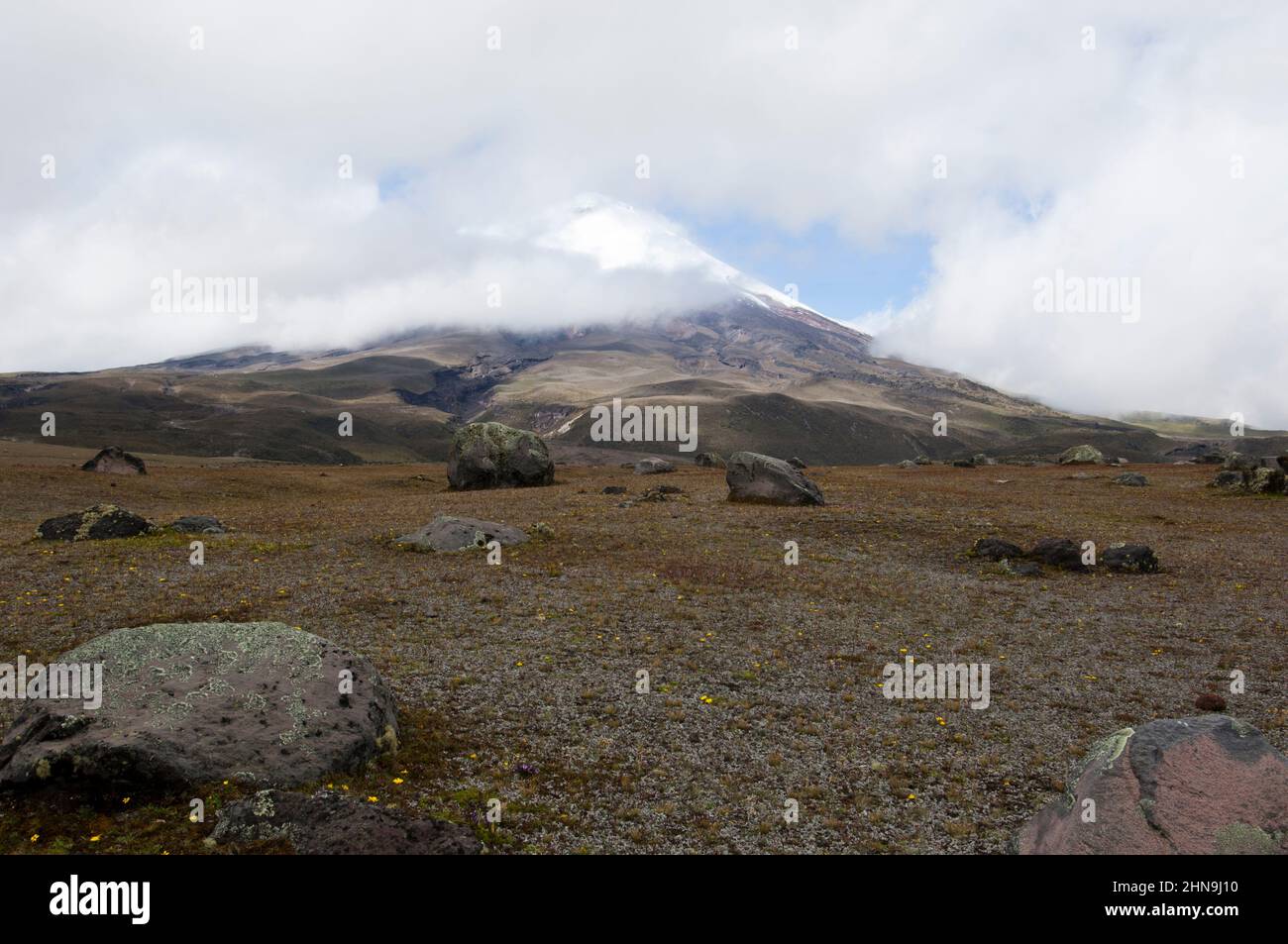 View of the Cotopaxi volcano, with volcanic rocks in the foreground ...