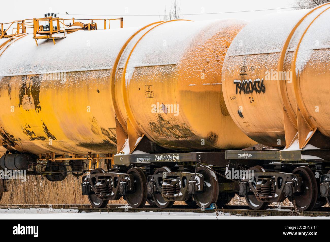 Snow covered tank-wagons of the cargo train standing on the railway ...