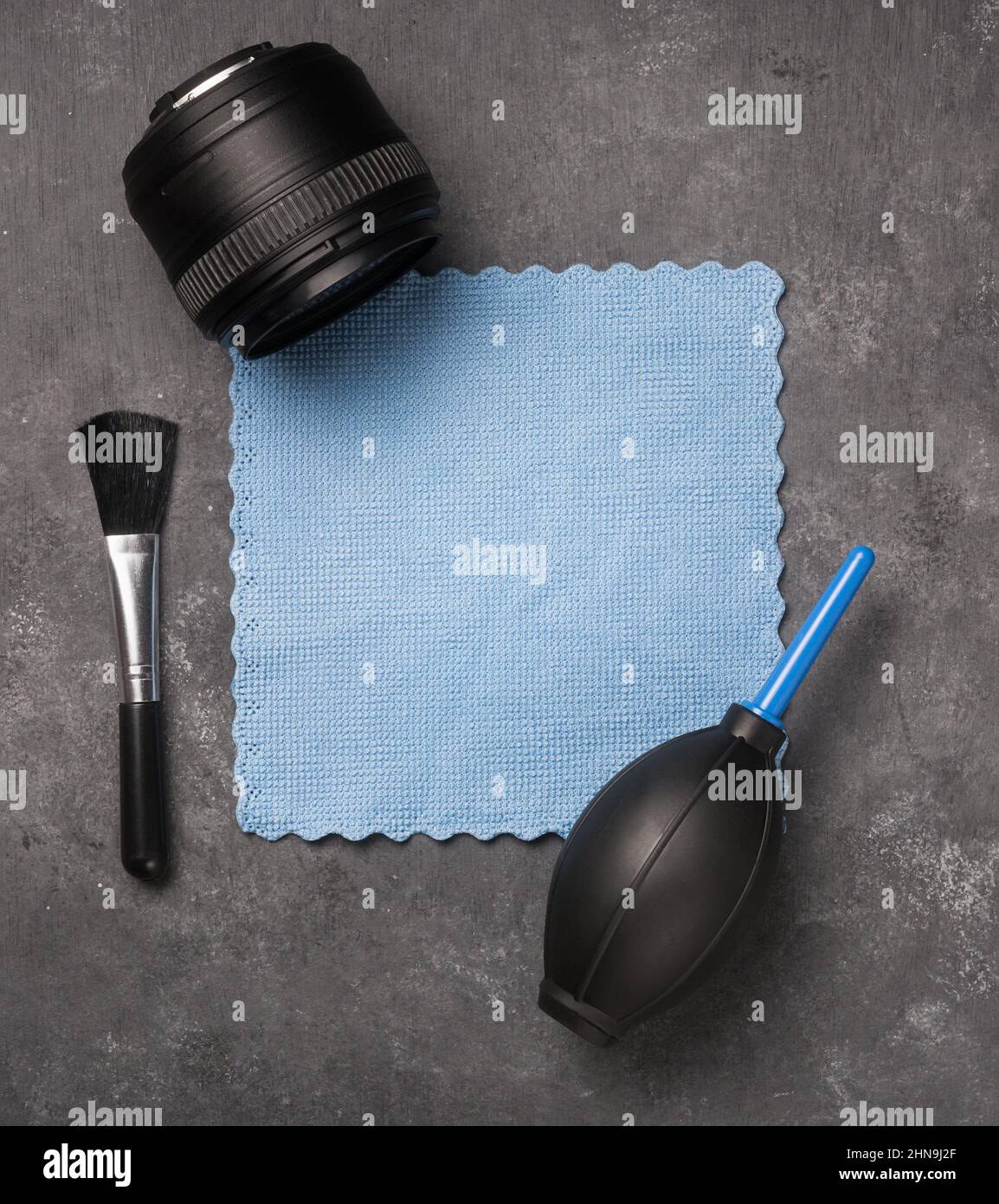 lens cleaning kit with dslr lens, on a textured background, camera ...