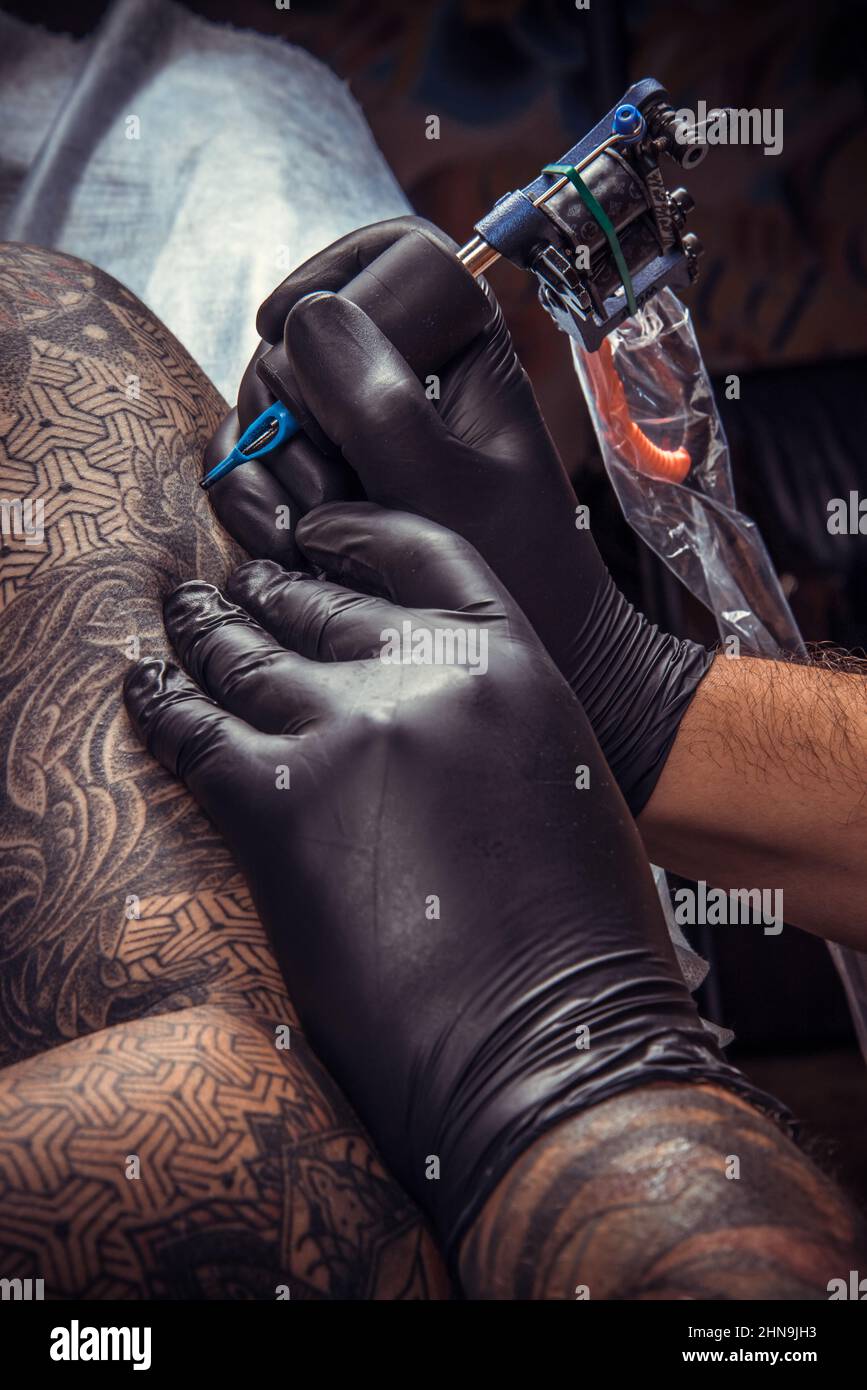 Tattoo artist posing in studio Stock Photo - Alamy