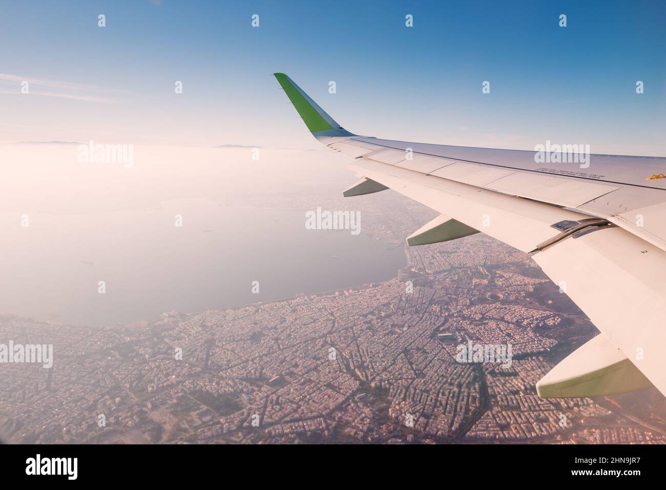 View from the window of the plane on the wing over the beautiful city ...