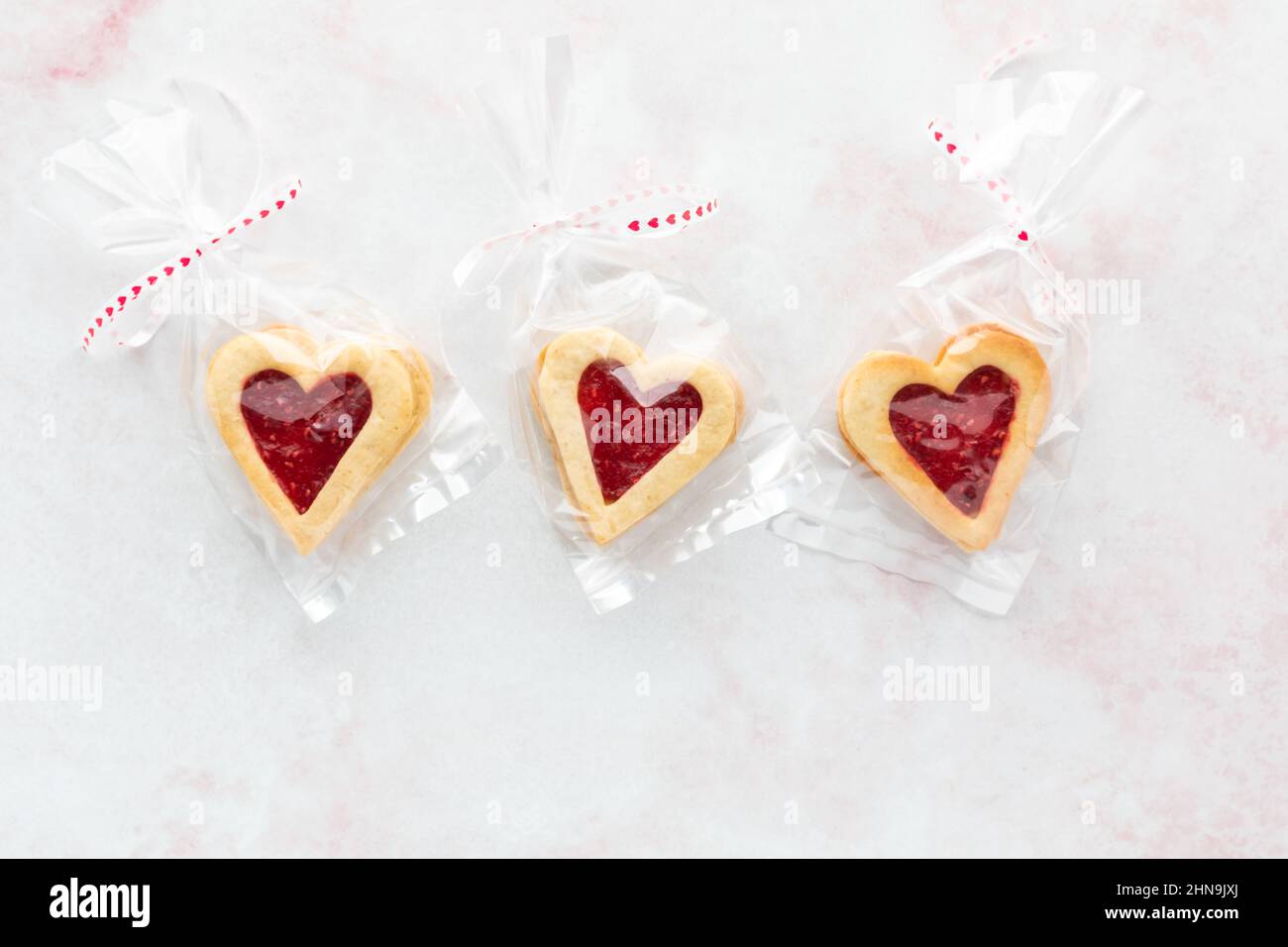 Heart shaped Linzer cookies wrapped in cellophane packages, for ...