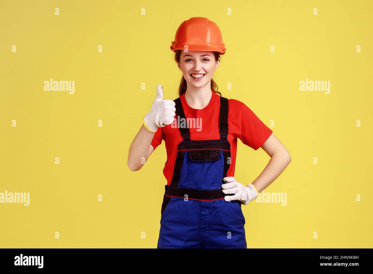 Portrait of satisfied worker woman standing and looking at camera ...