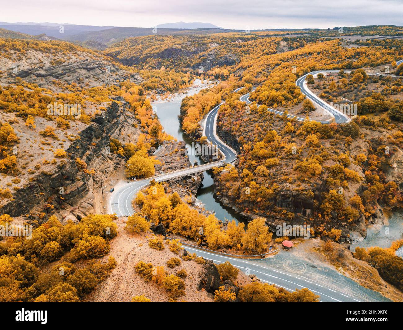 Aerial panoramic view of Venetikos river and serpentine highway road in ...