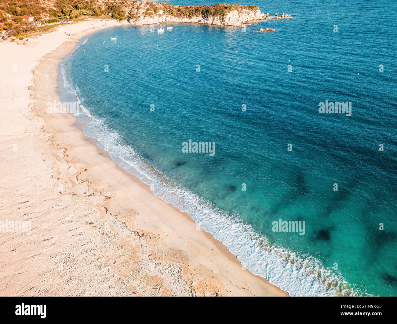 Aerial view of an idyllic sea sandy beach with an incoming azure wave ...