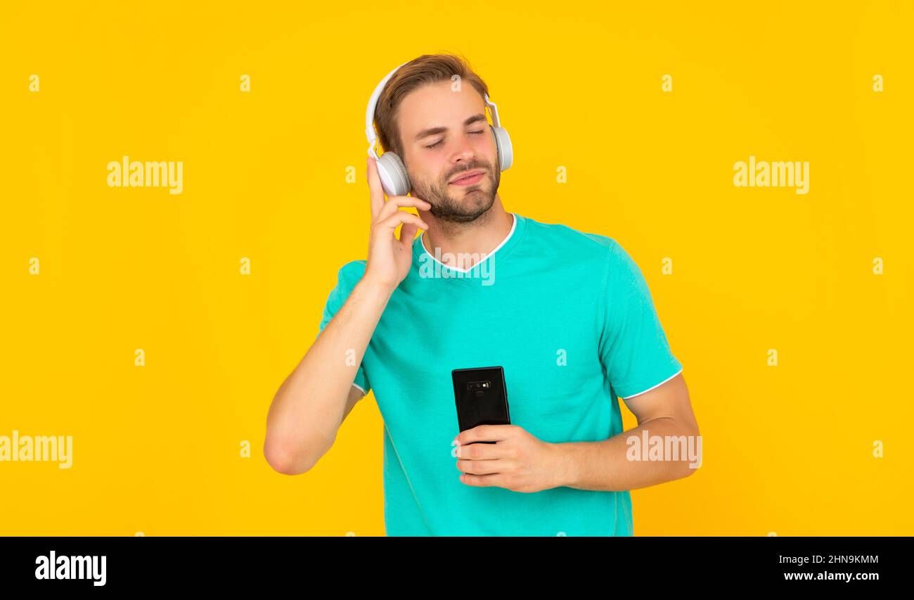 Enjoy your day with positivity. Happy guy enjoy music in headphones ...