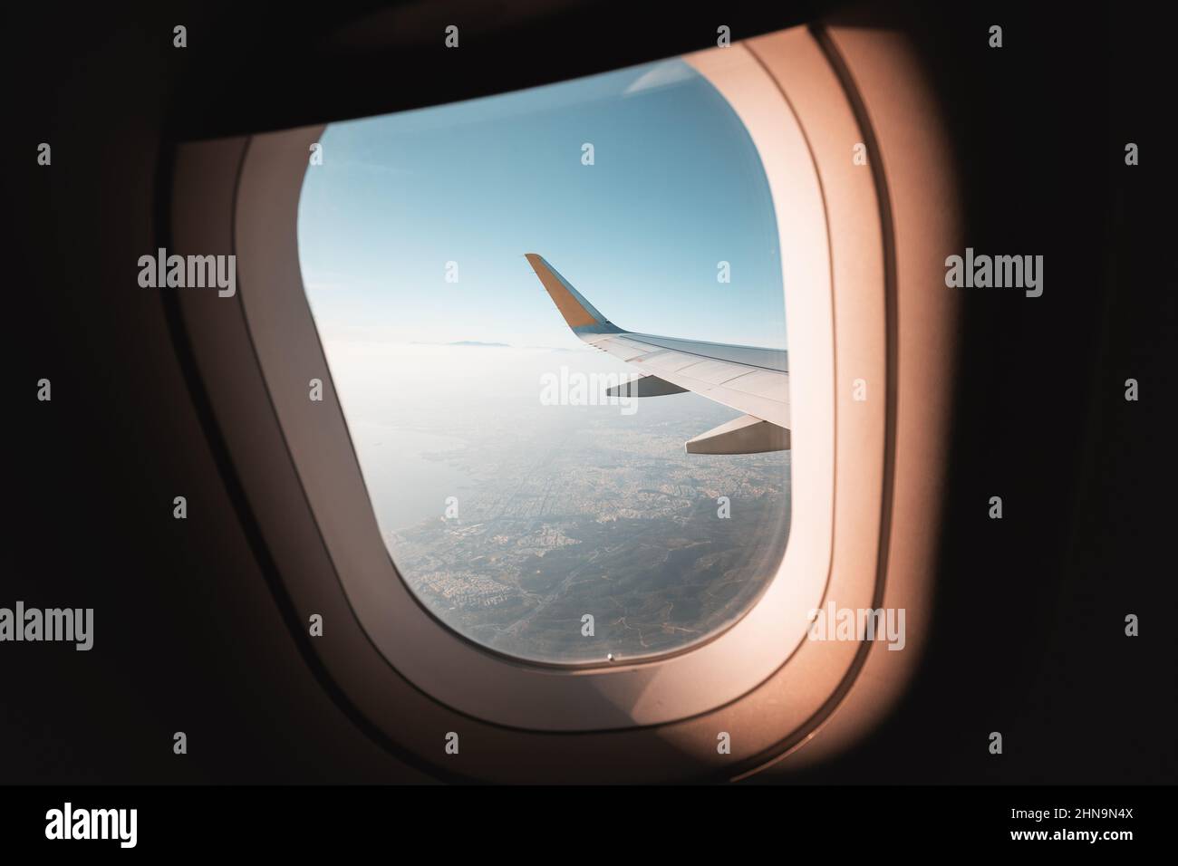 View from the window of the plane on the wing over the beautiful city ...