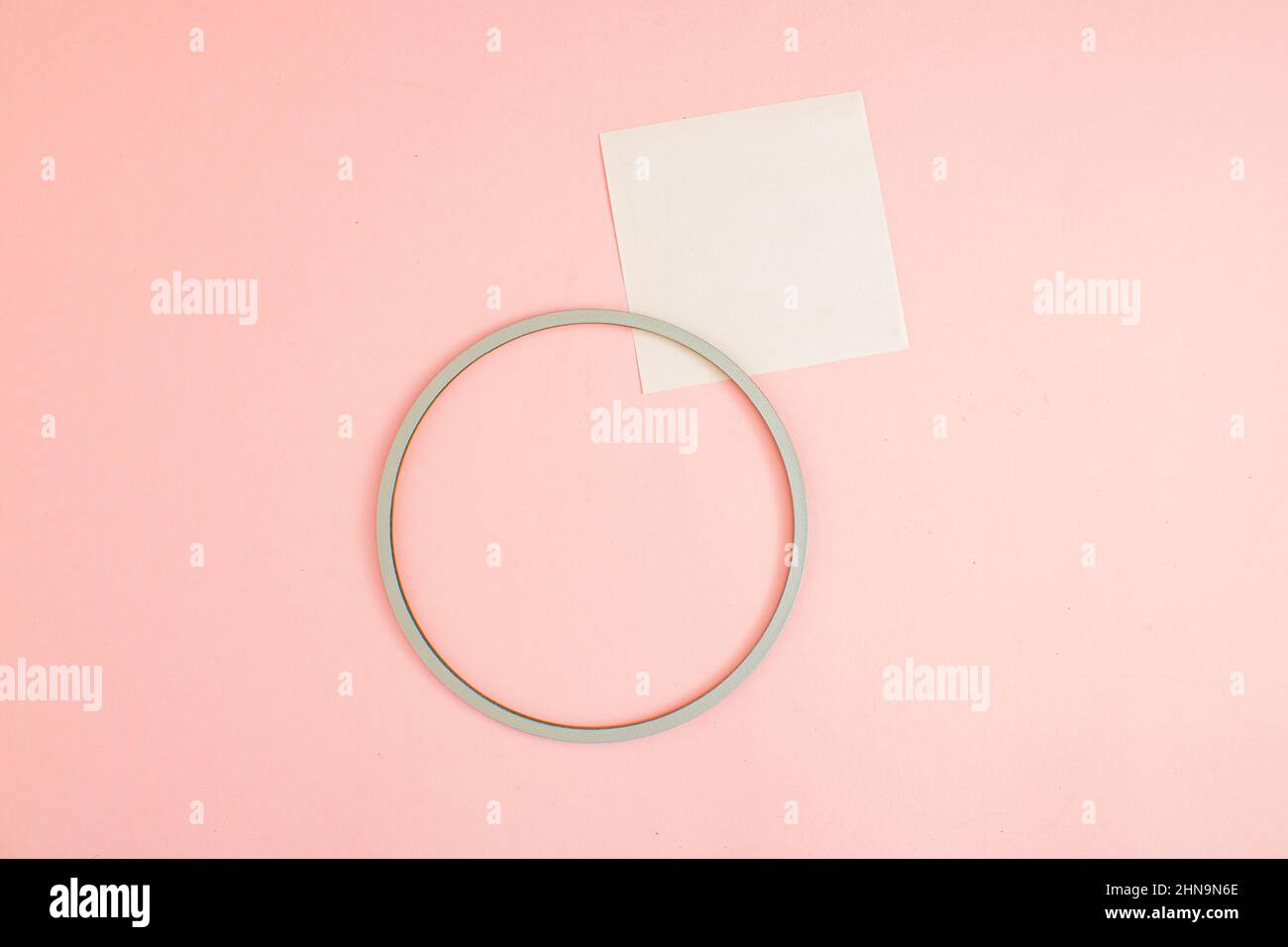 3D rendering of a circle-shaped frame and square blank paper against a ...