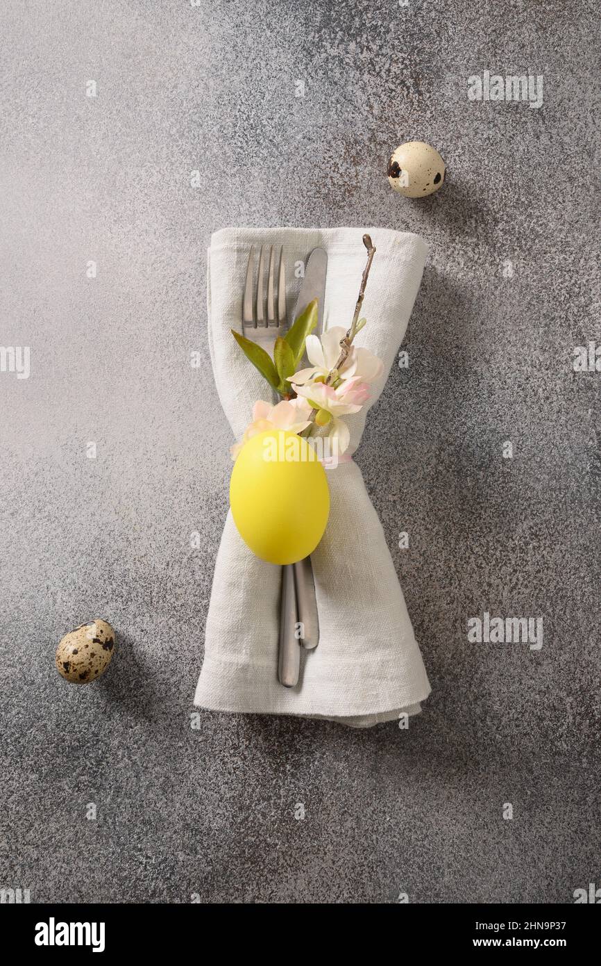 Cutlery with spring decorations, yellow egg and blossom flowers for ...