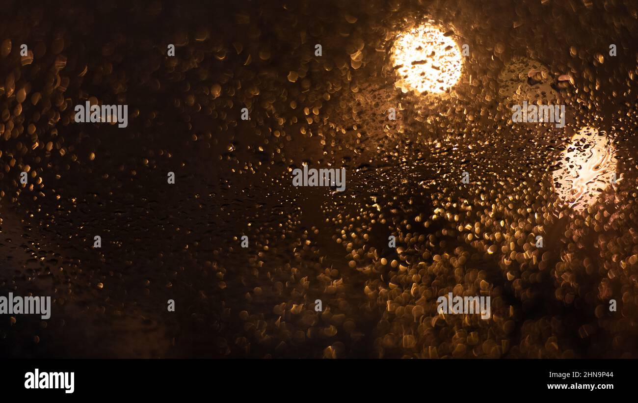 Blurred background with raindrops and lights Stock Photo - Alamy
