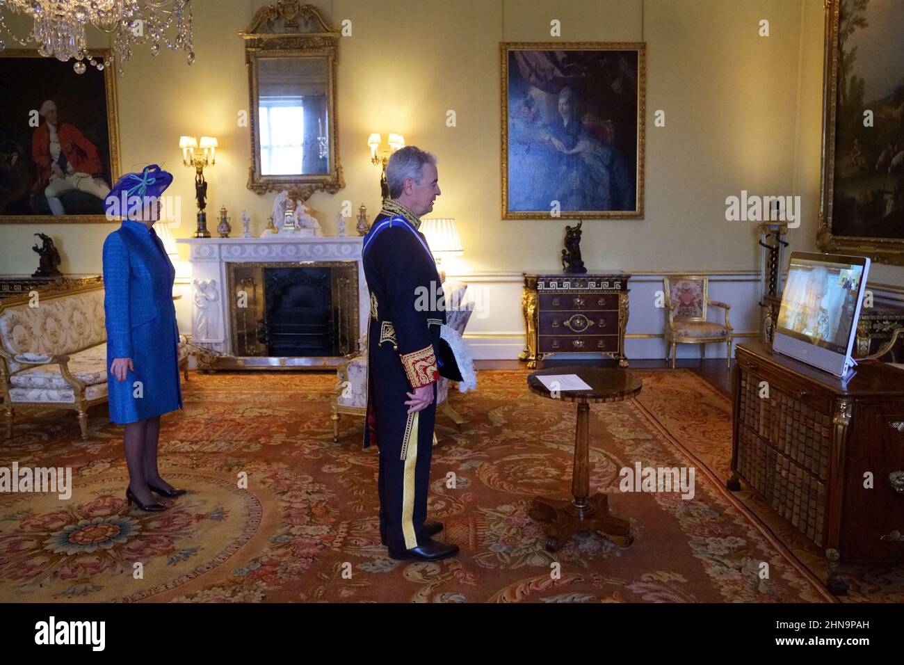 Queen Elizabeth II appears on a screen via videolink from Windsor ...