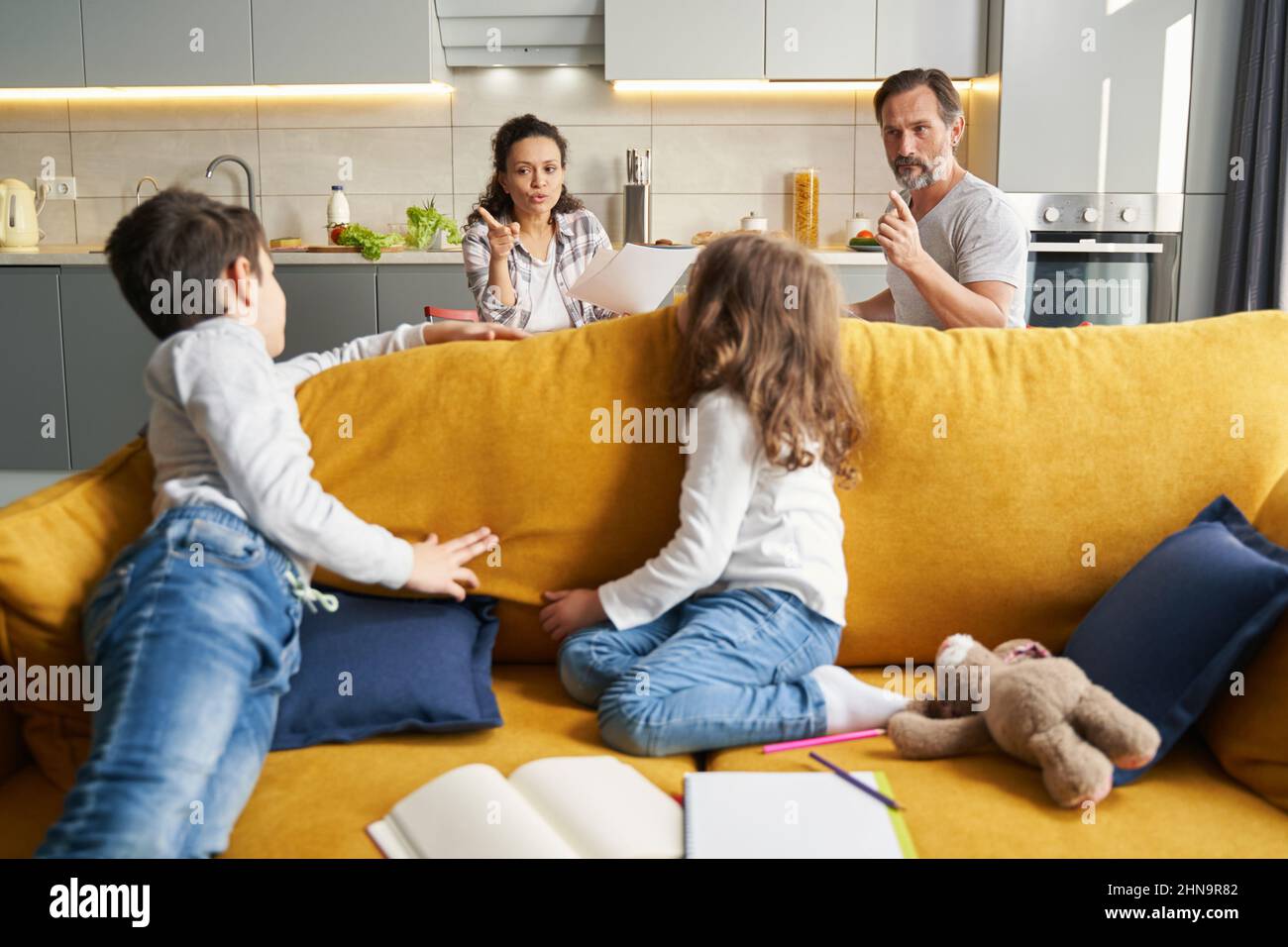 Father and mother warning children against figting each other Stock ...
