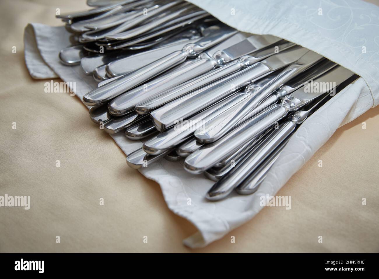 There are a lot of cutlery in a napkin in a restaurant Stock Photo - Alamy