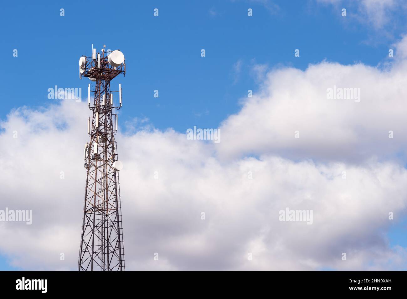 A high-rise telecommunications tower made of metal structure against a ...