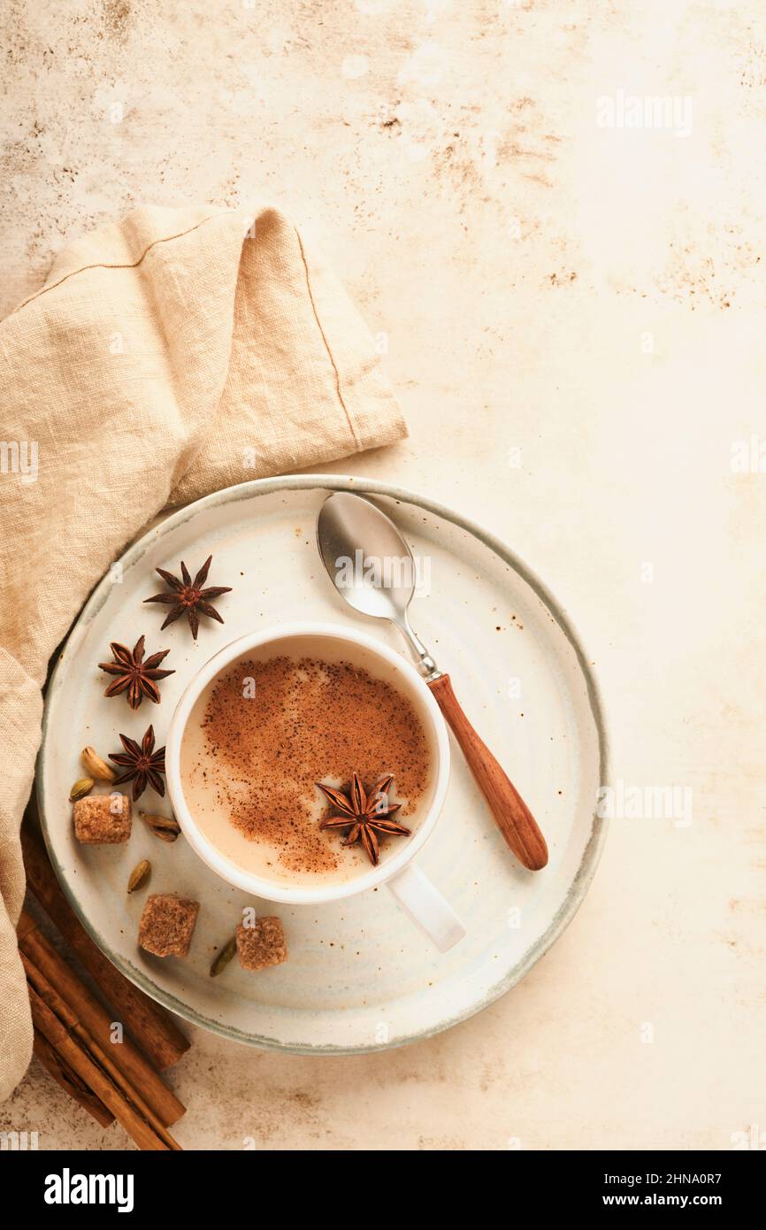 Masala tea. Masala chai spiced tea with milk and spices on light warm ...
