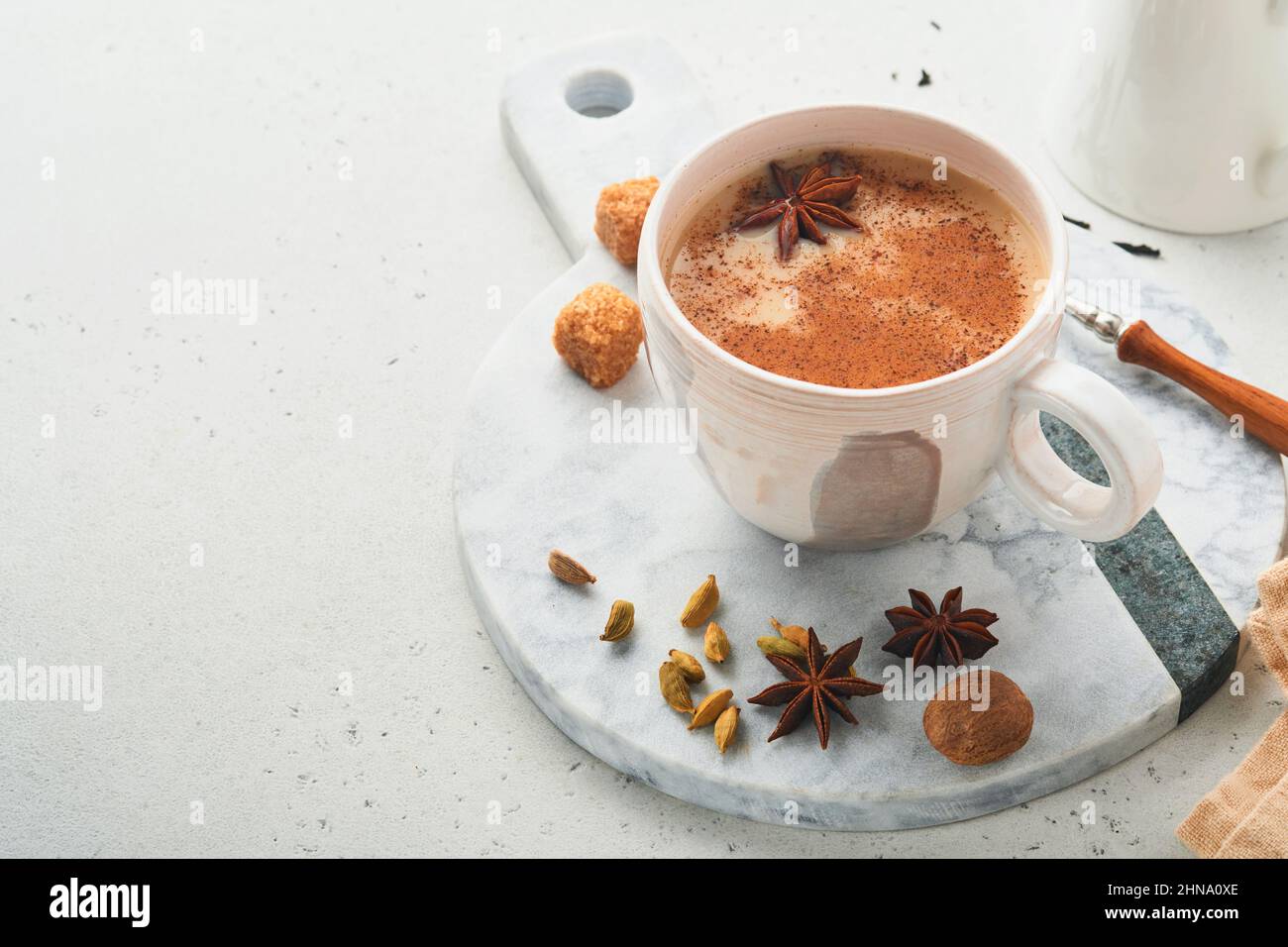 Masala tea. Masala chai spiced tea with milk and spices on light grey ...