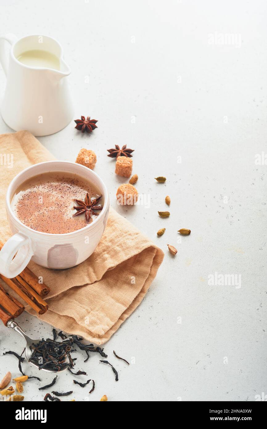 Masala tea. Masala chai spiced tea with milk and spices on light grey ...