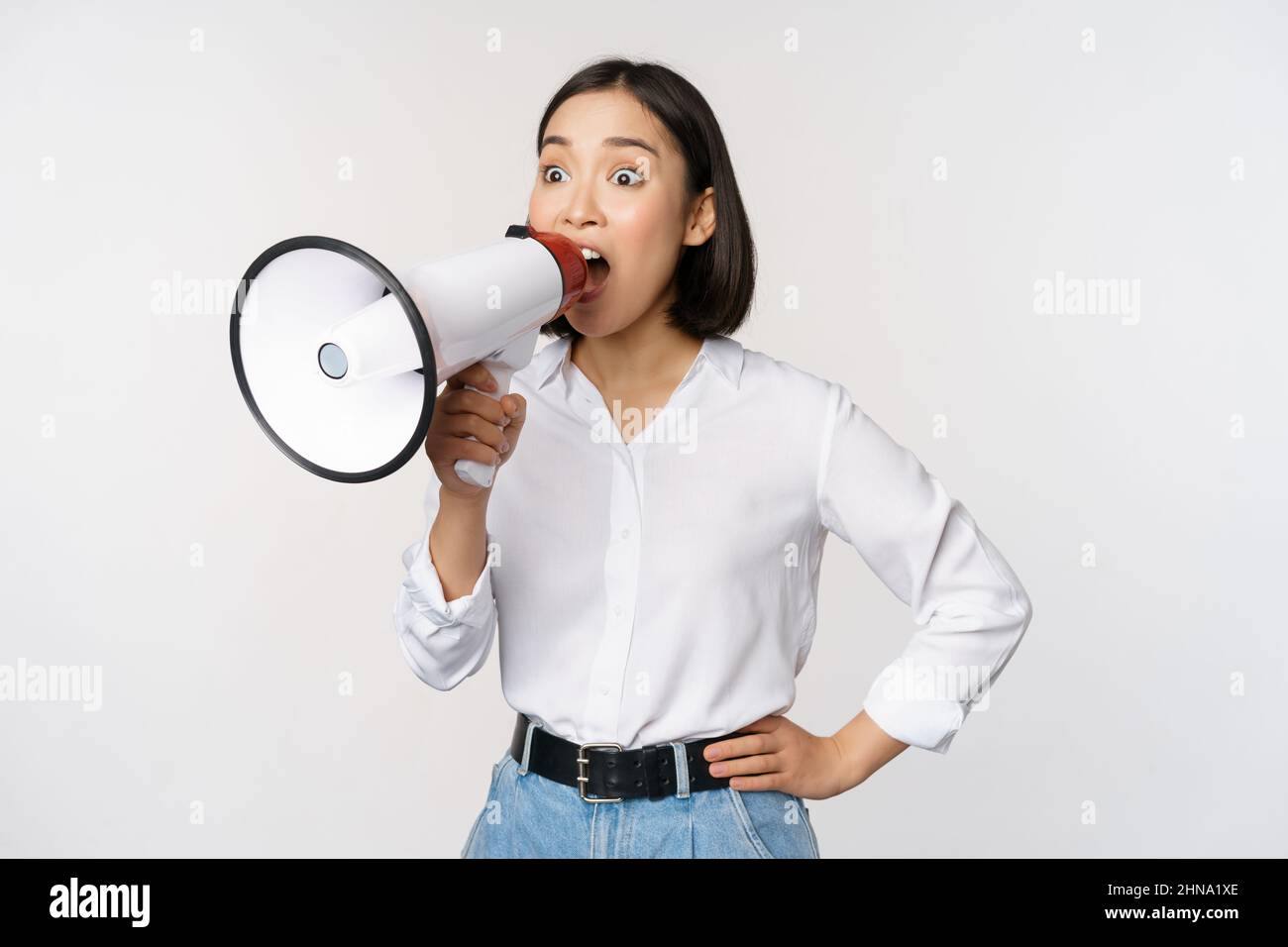 Image of young woman, korean activist, recruiter screaming in megaphone ...