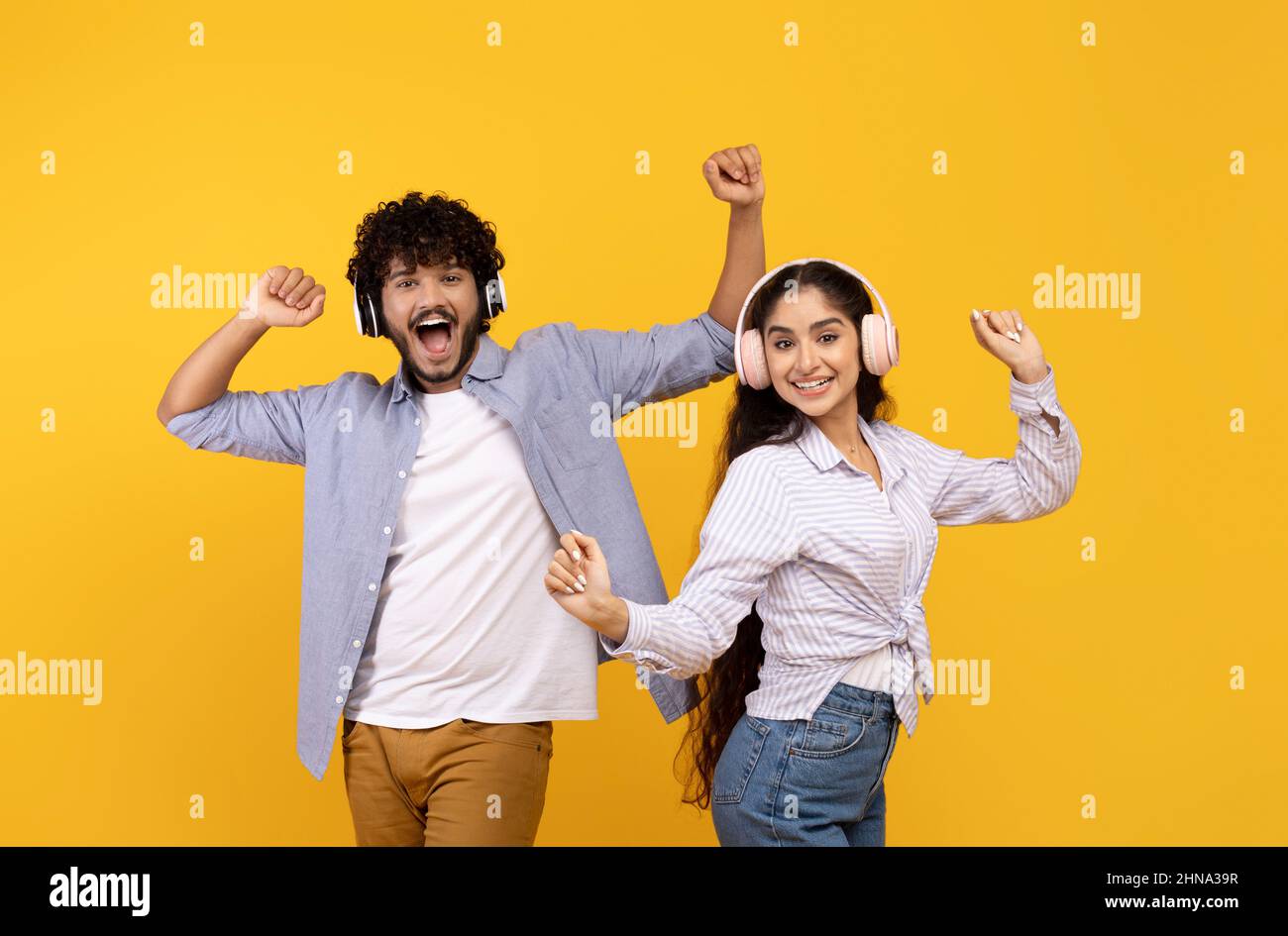 Have fun and enjoy music together. Happy young indian couple dancing in ...