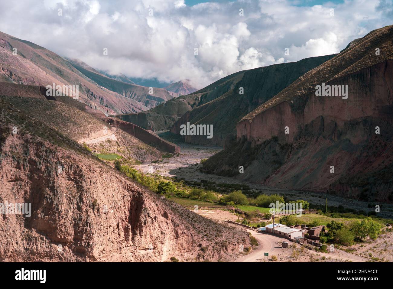 White building built in a huge valley with a single road leading to it ...