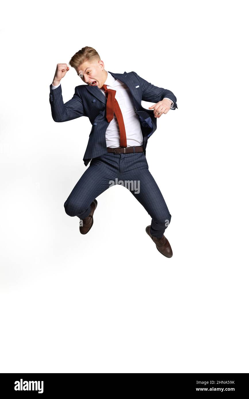 Excited young businessman, student, diplomat jumping isolated on white ...