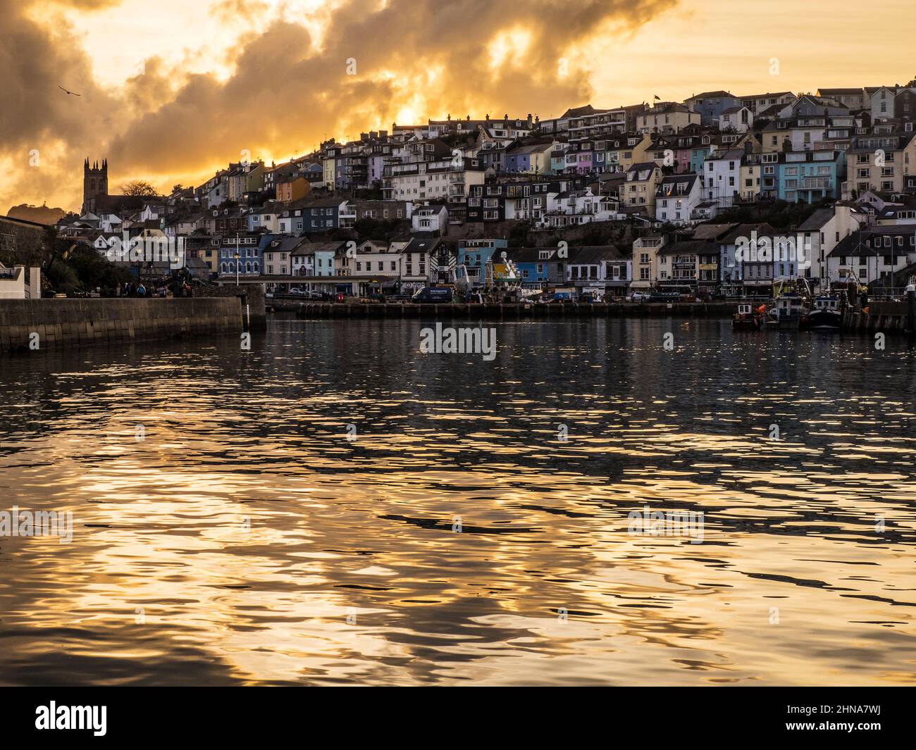 A dramatic stormy sunset over All Saints' Church in Brixham, Devon ...