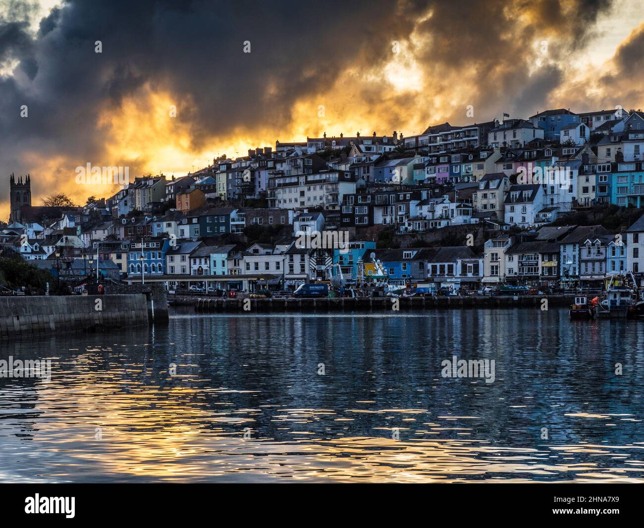 A dramatic stormy sunset over All Saints' Church in Brixham, Devon ...