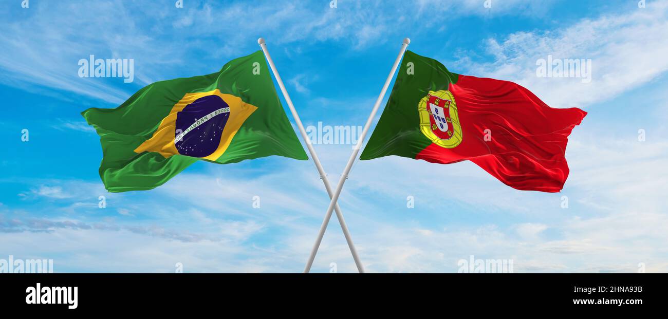 crossed national flags of Brazil and portugal flag waving in the wind ...