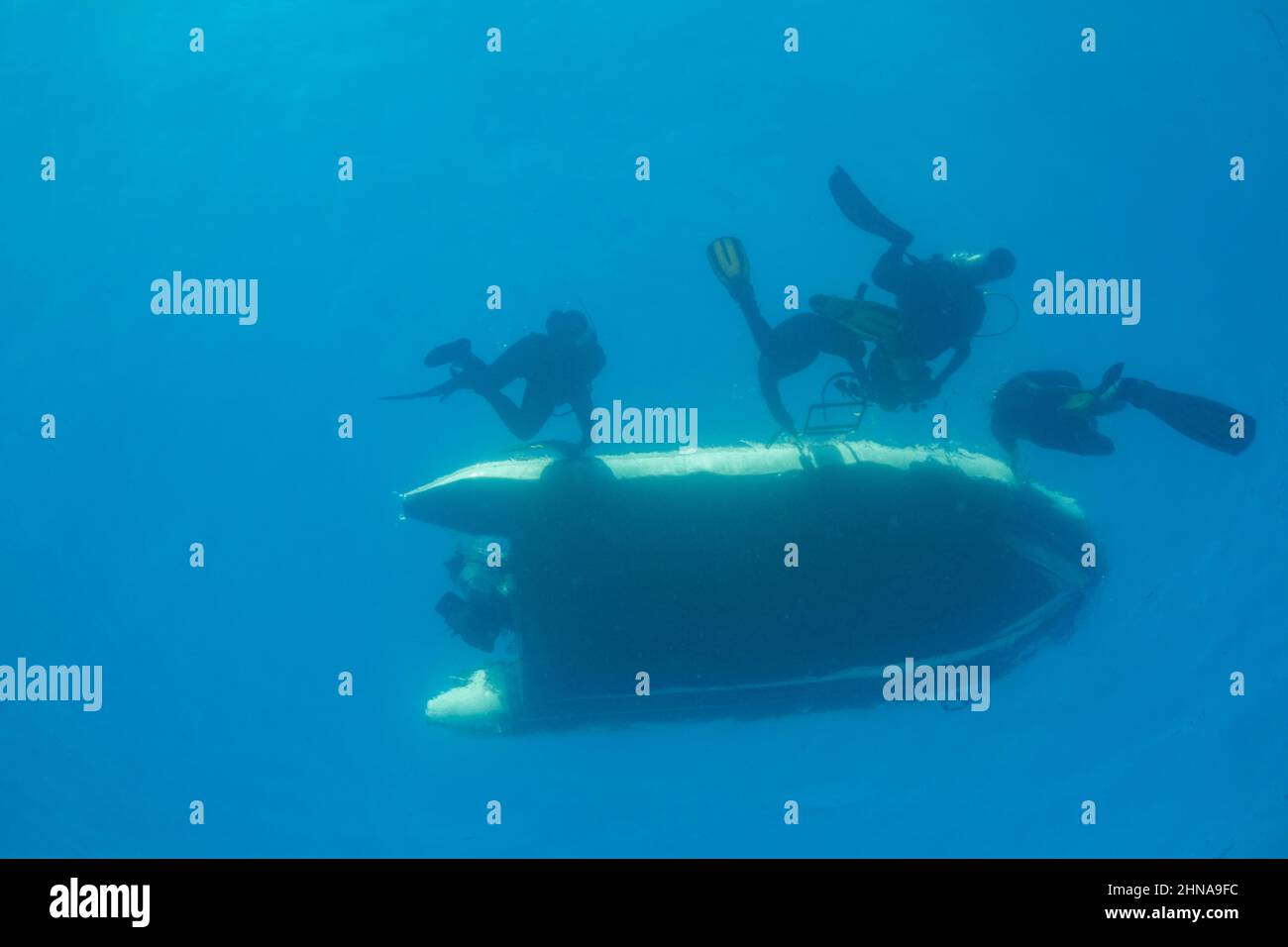 A view from underwater of divers (MR) being picked up by an inflatable ...