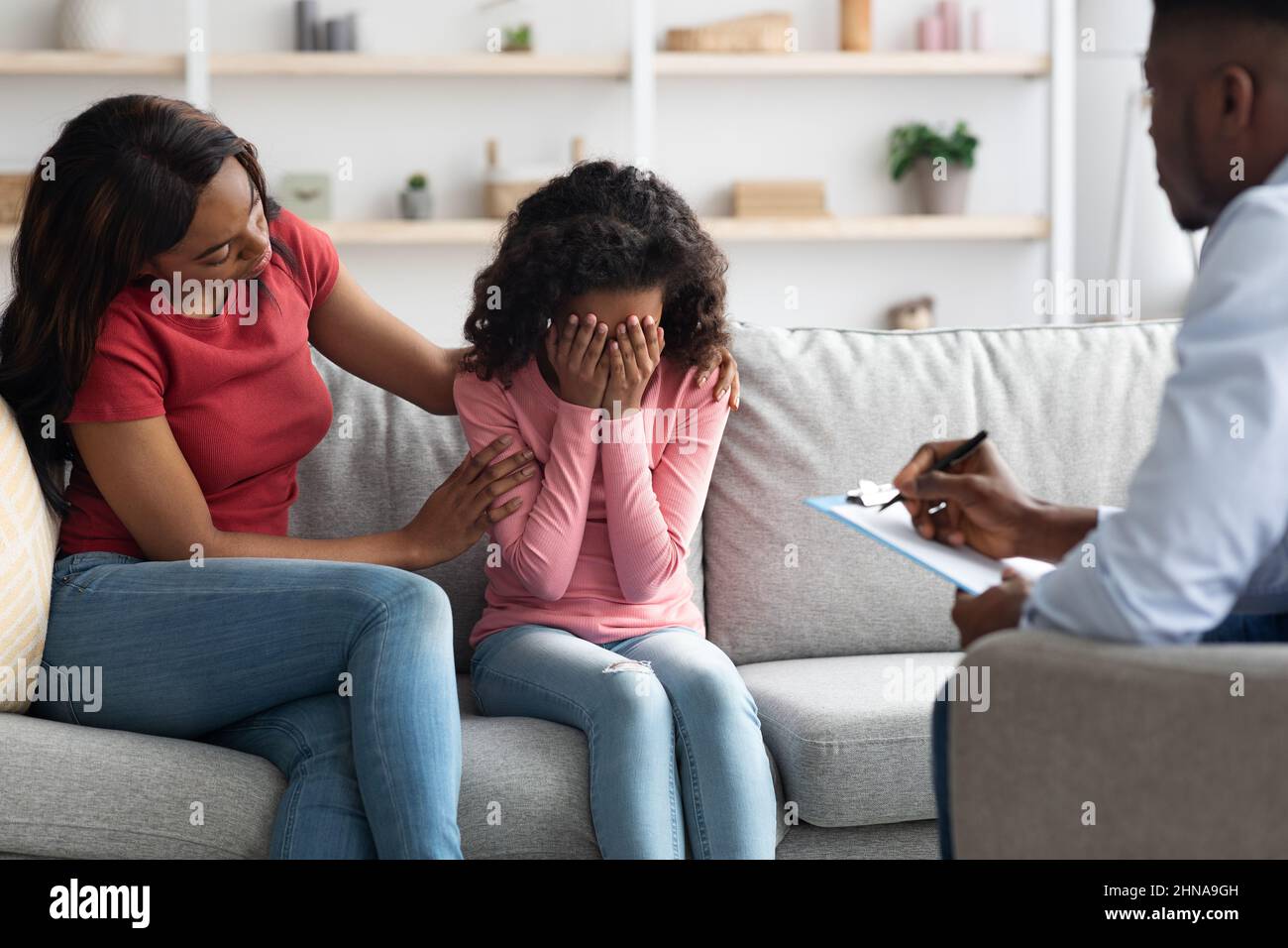 African american girl crying during therapy session with child ...
