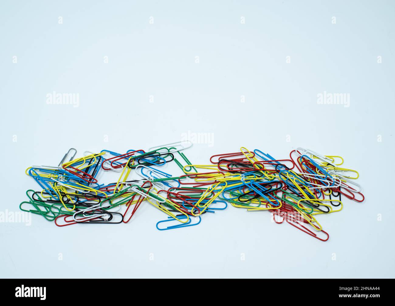 Multi coloured, blue, red, yellow, black and green paper clips in a ...