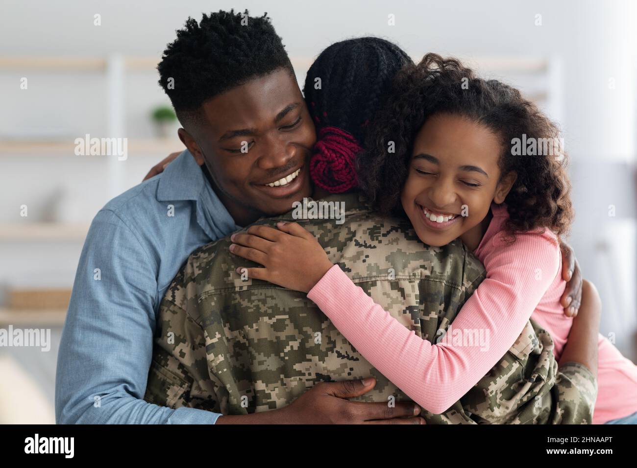 Closeup portrait of happy african american family greeting mother ...