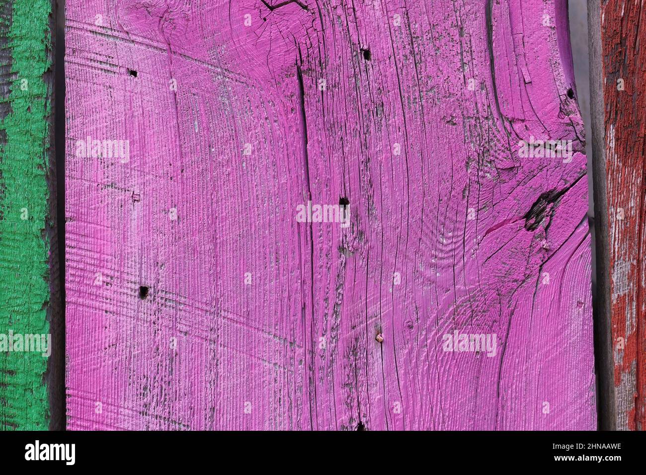 Close-up of grooves and saw marks on surface of pink painted wood plank ...