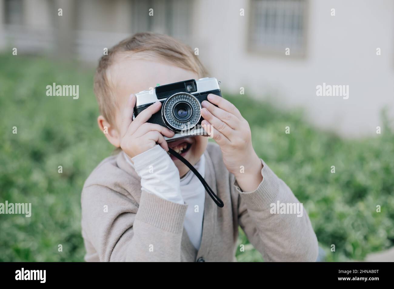 Little happy boy hold film analogue vintage retro photo camera Stock ...