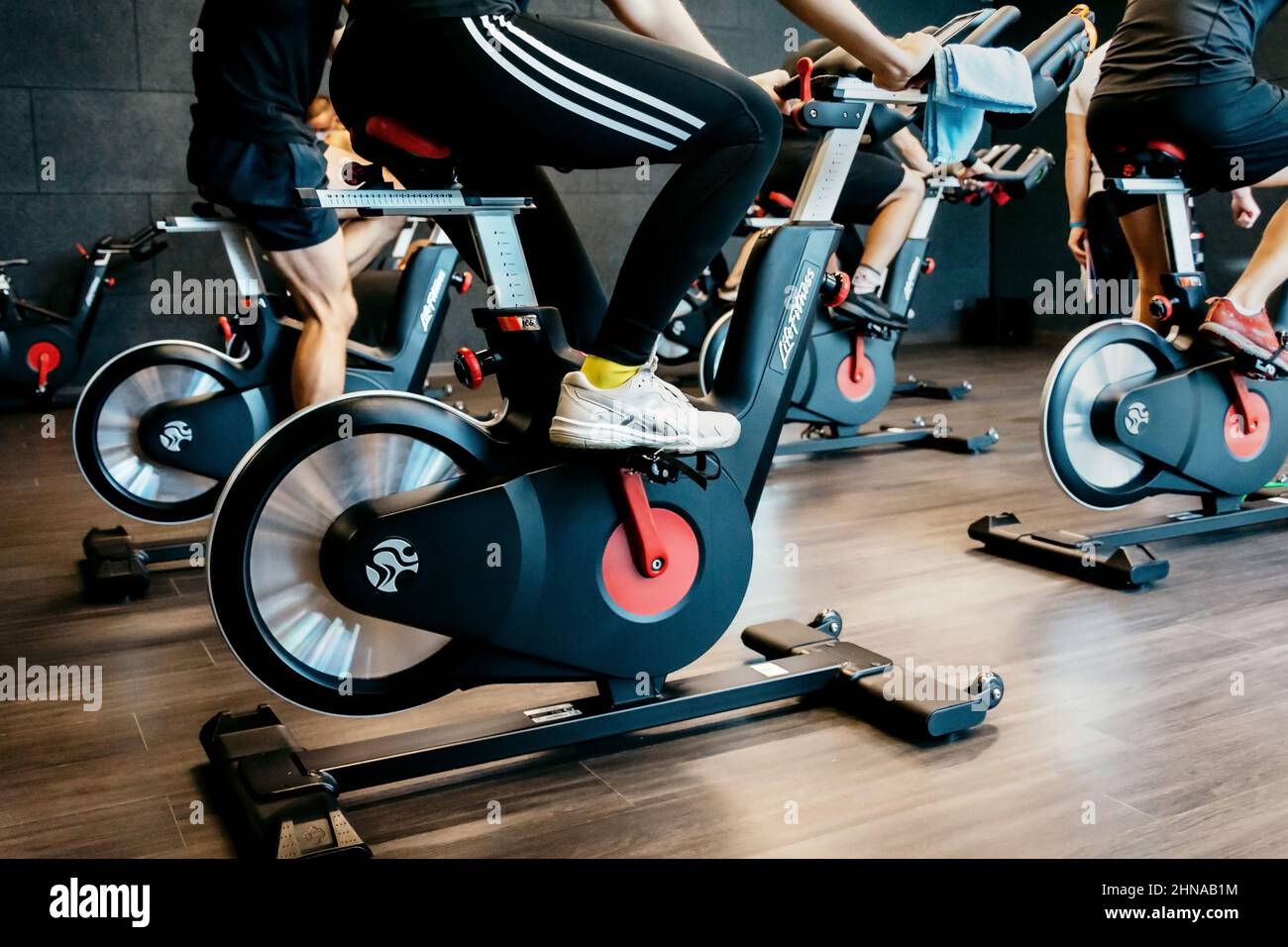 A group of athletes on exercise bikes in the gym Stock Photo - Alamy