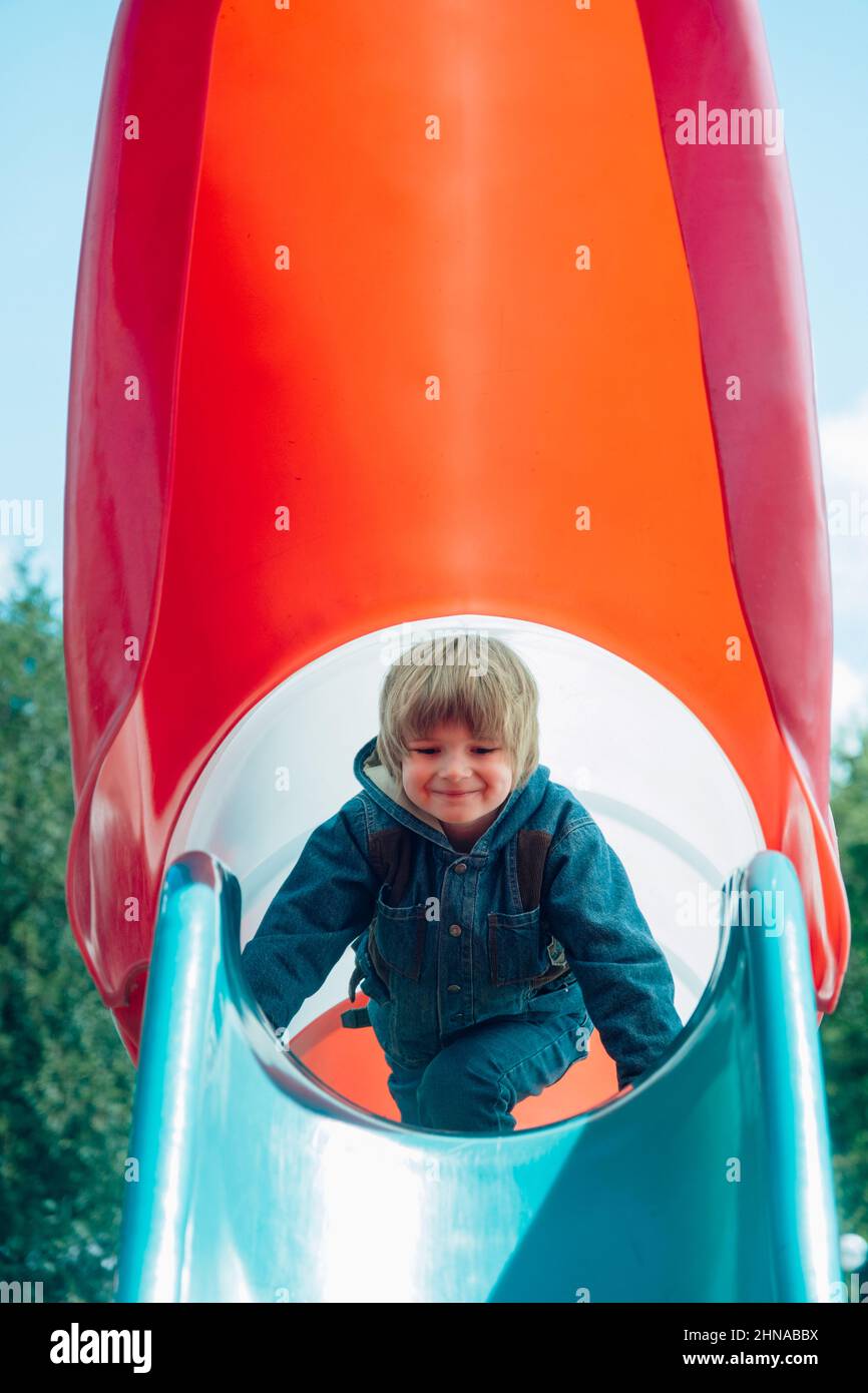 Happy Kid at the slide Stock Photo - Alamy