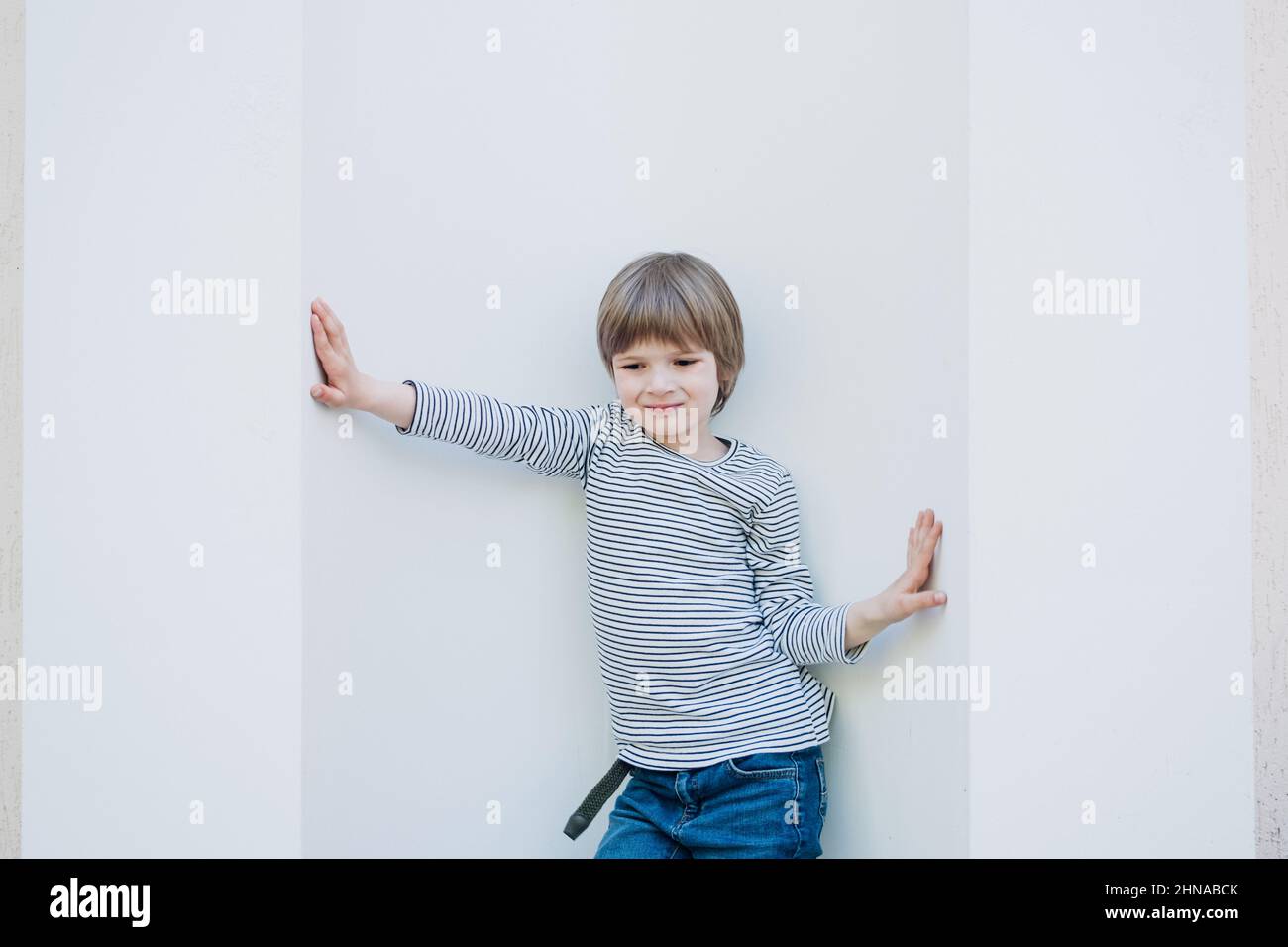 Kid having fun at the white wall Stock Photo - Alamy
