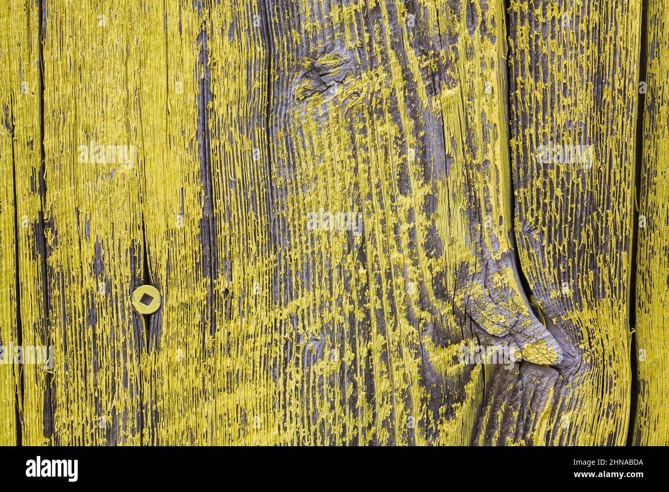 Close-up of grooves and saw marks on surface of yellow painted wood ...