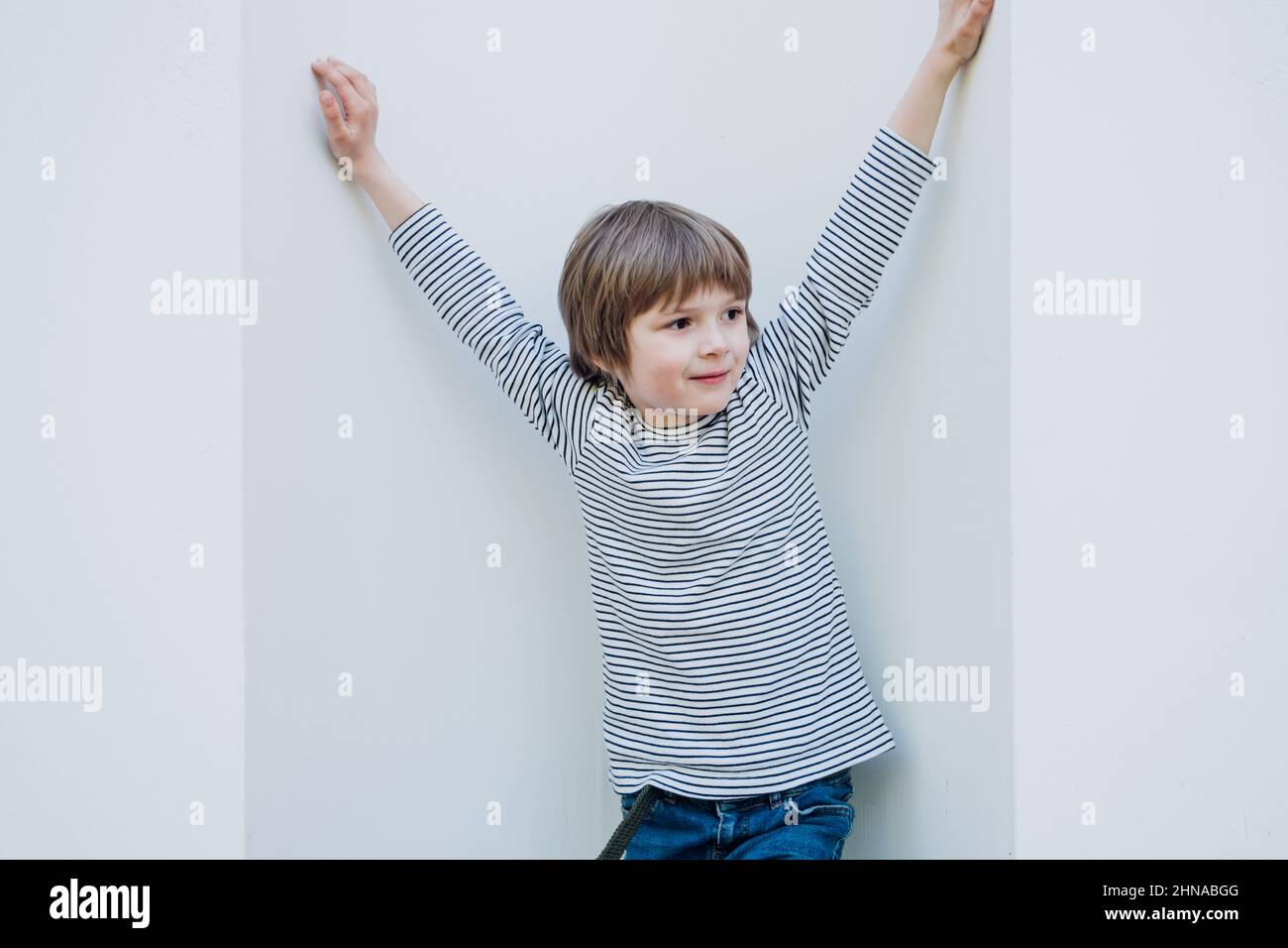 Kid having fun at the white wall Stock Photo - Alamy
