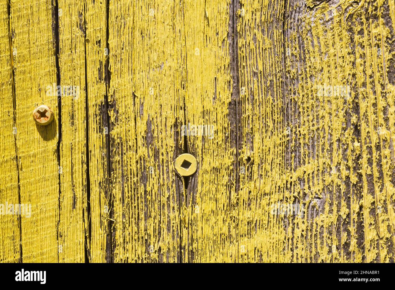 Close-up of grooves and saw marks on surface of yellow painted wood ...