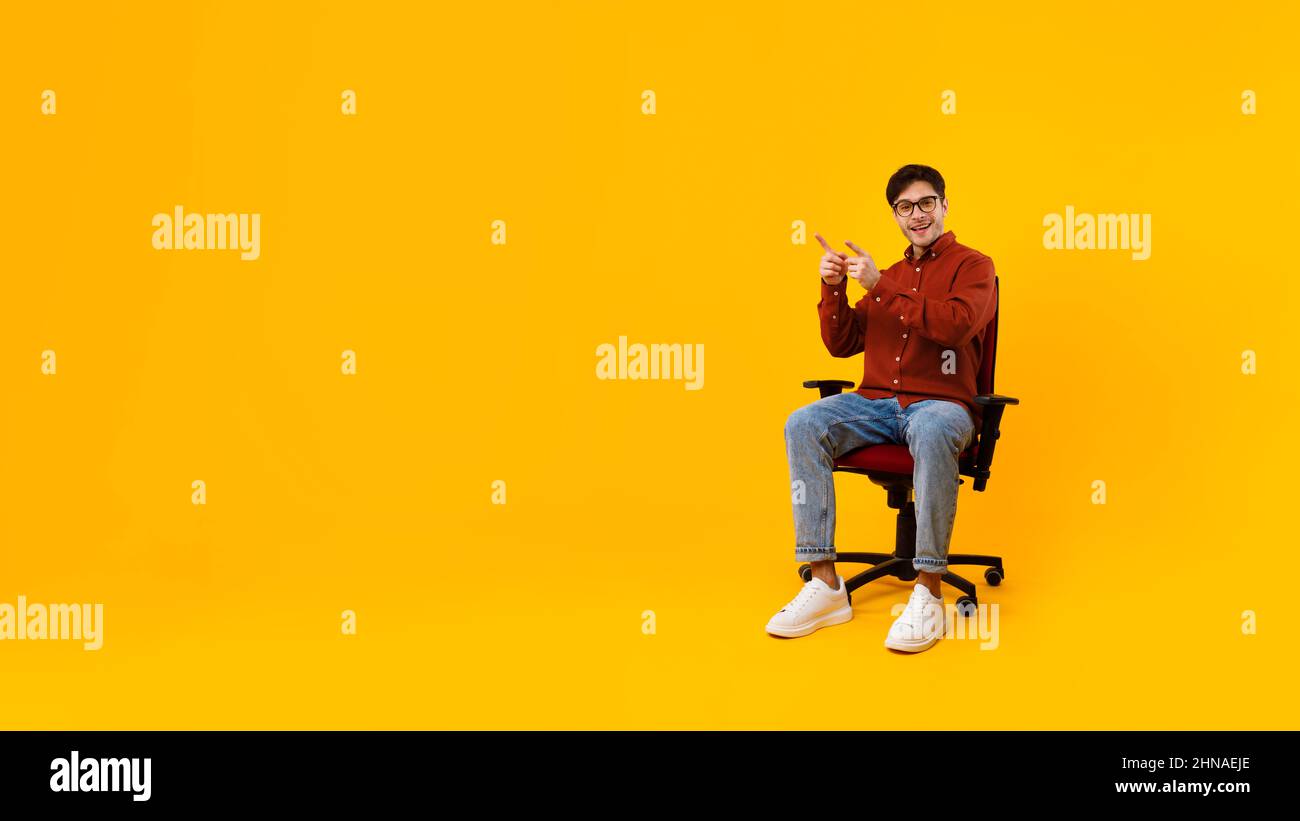 Man Pointing Fingers Aside Showing Free Space Sitting, Yellow ...