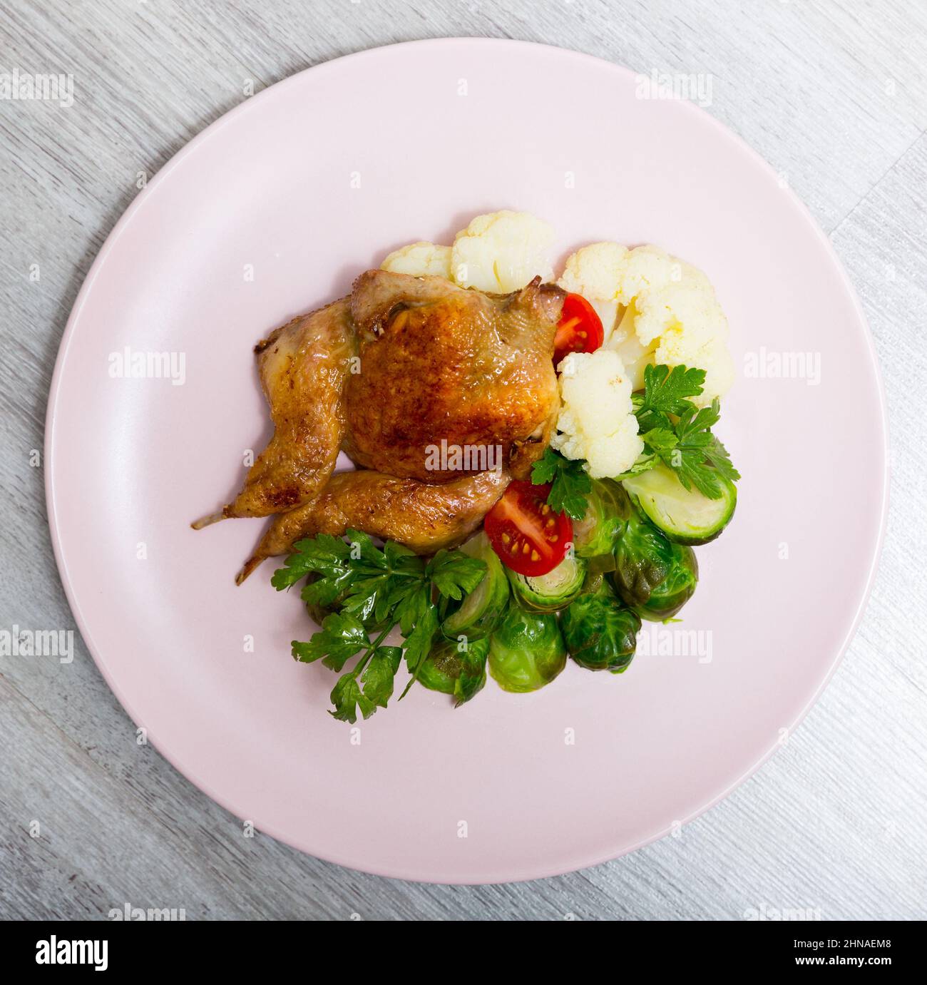 Top view of tobacco quail with steamed vegetables Stock Photo - Alamy