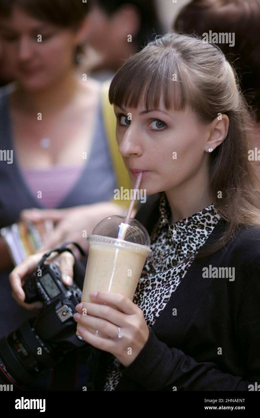 Woman with camera drinks juice at Gothic quarter in Barcelona Stock ...