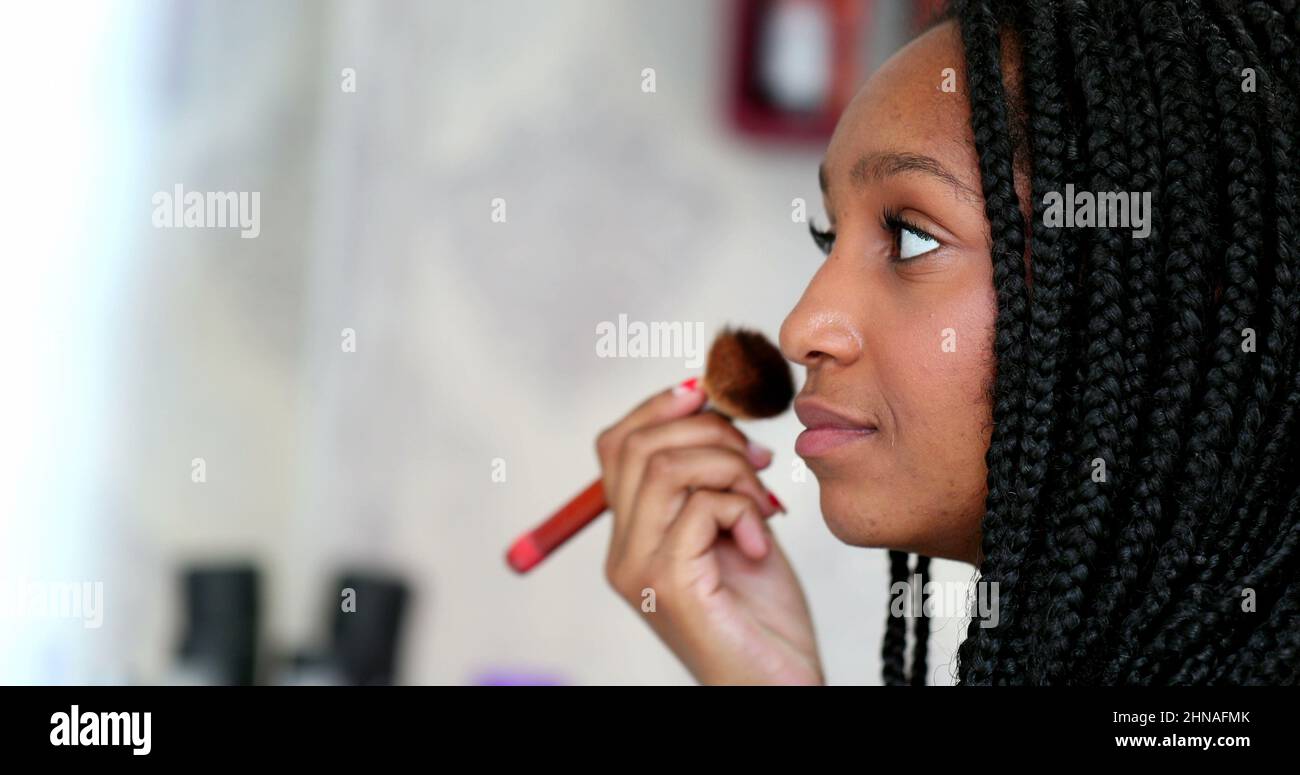 African black teen applying make-up Stock Photo - Alamy