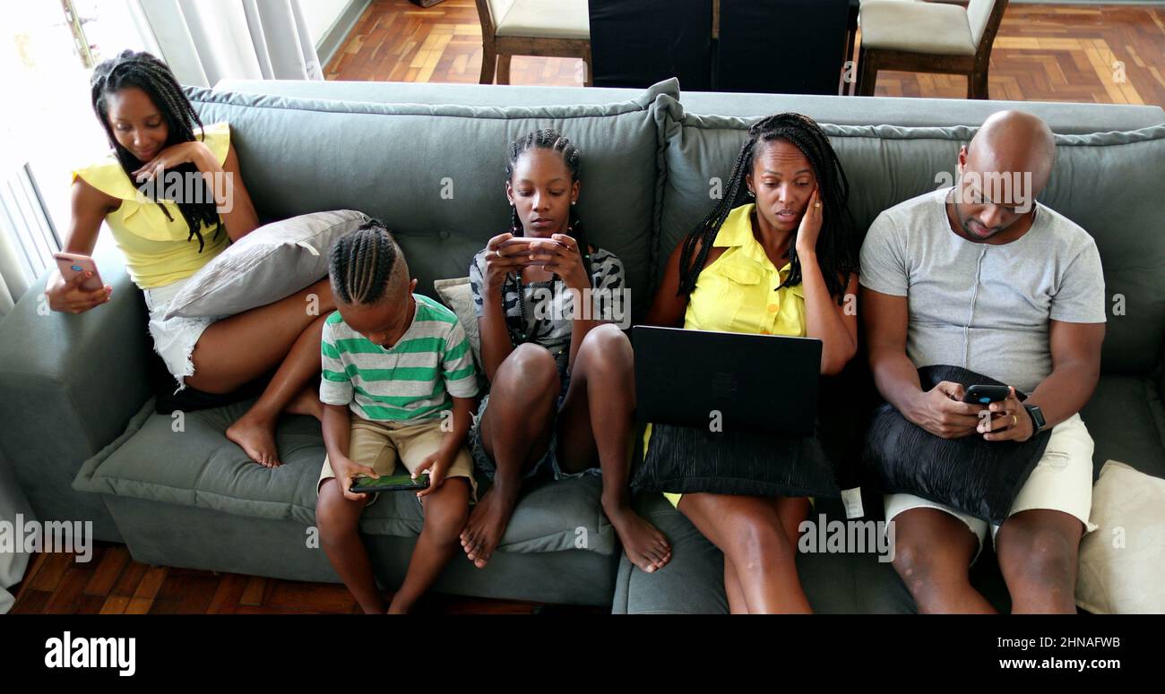 African family using technology at home sofa Stock Photo - Alamy