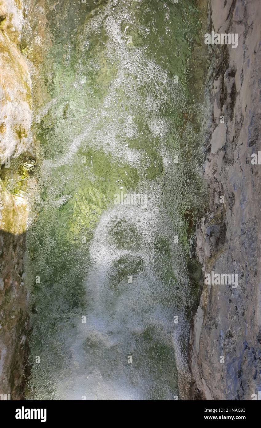 Background of mineral water flow from a spring in Pamukkale, Turkey ...