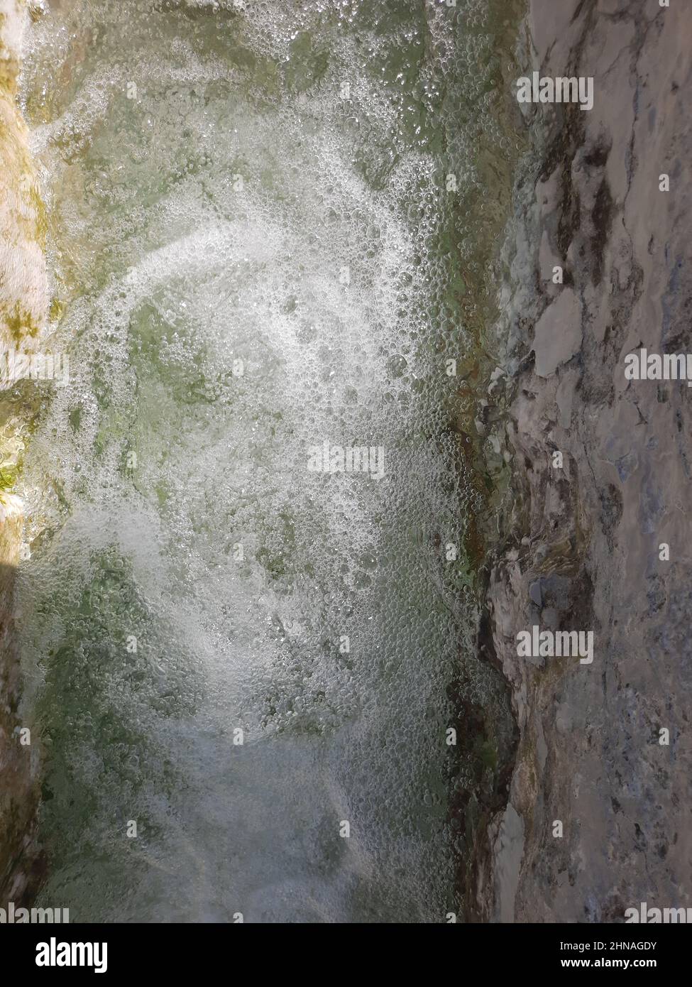 Background of mineral water flow from a spring in Pamukkale, Turkey ...