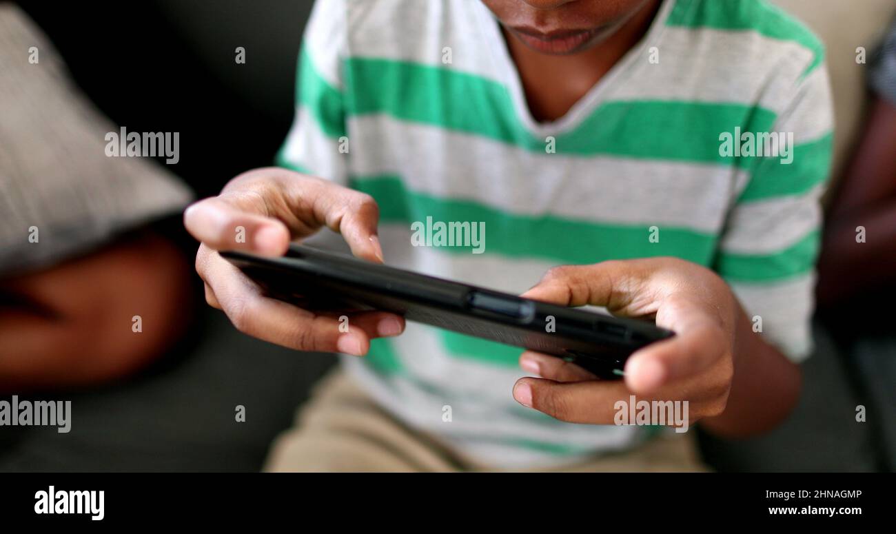 Child hands using cellphone close-up. African black ethnicity kid hand ...
