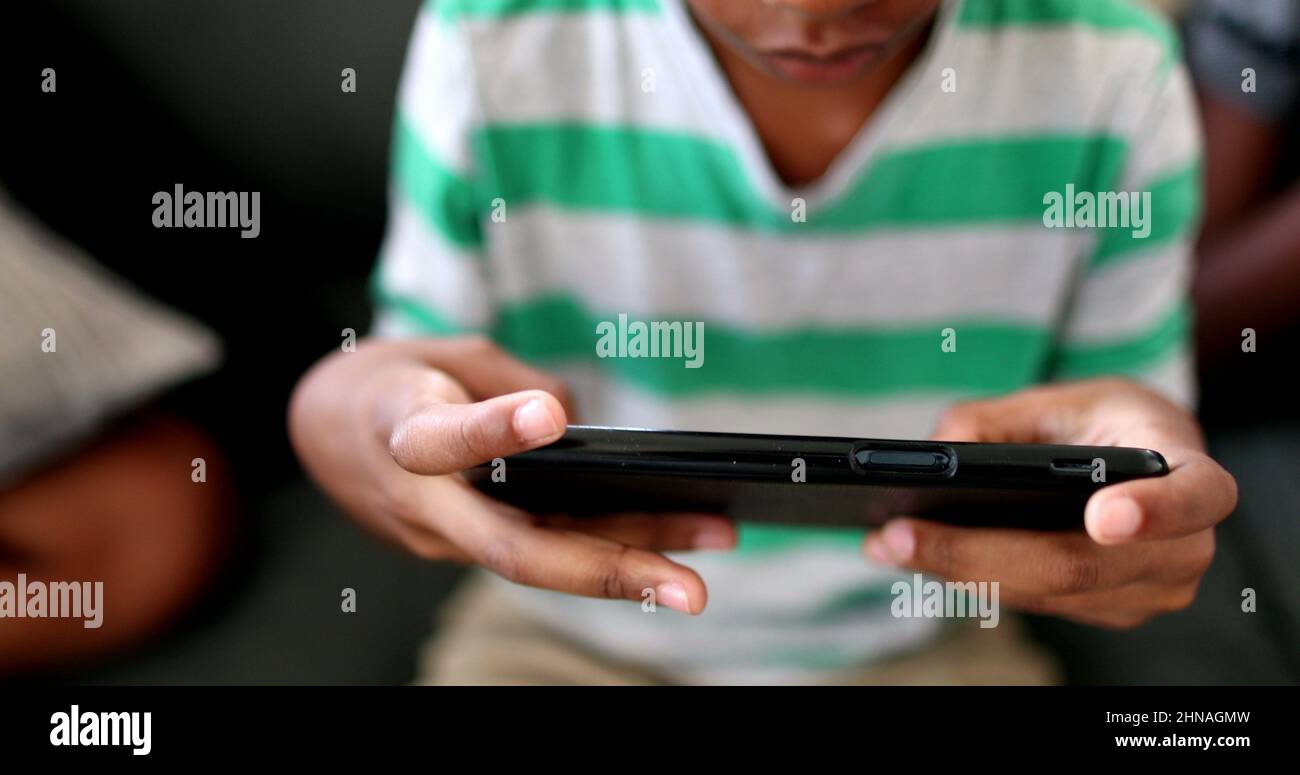 Child hands using cellphone close-up. African black ethnicity kid hand ...