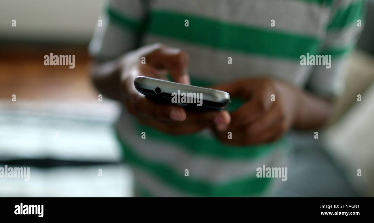 Child holding smartphone device. Mixed race black african boy kid using cellphone at home Stock ...